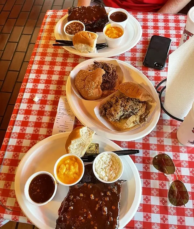 BBQ spread that would make a vegetarian question their life choices. Three plates, two people, zero regrets—math works differently when barbecue is involved.