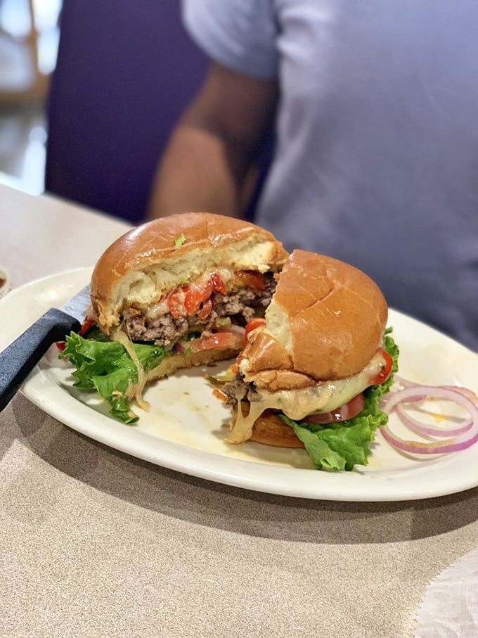 This isn't just a burger—it's an architectural marvel of bacon, cheese, and beef that requires both hands, several napkins, and zero shame.
