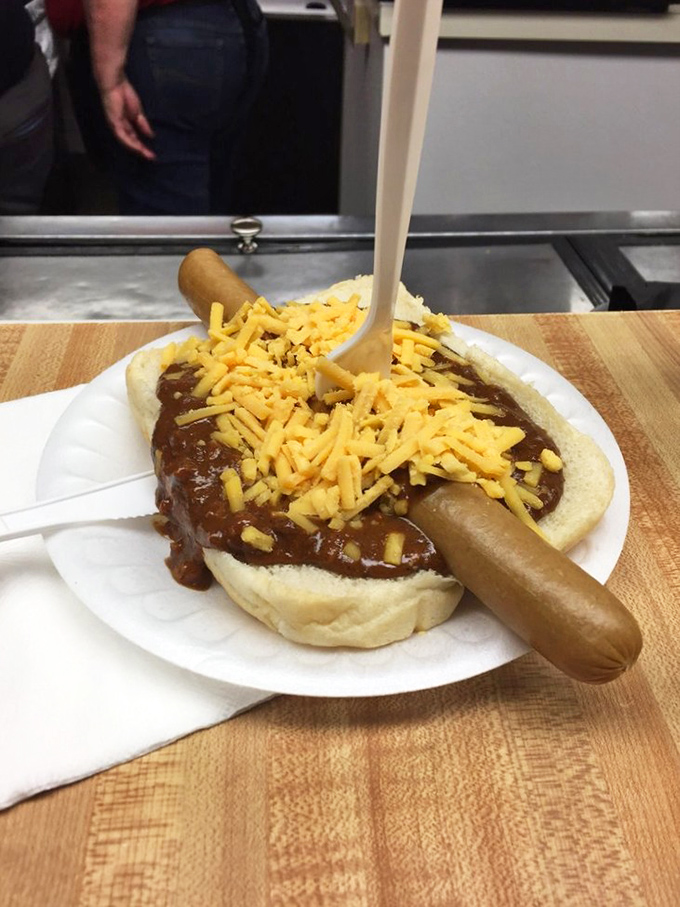 The footlong chili dog arrives like a Midwestern viking ship, sailing through a sea of cheese on its journey to comfort food Valhalla.