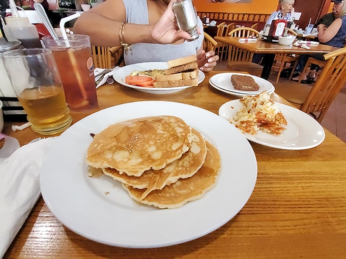 Stack of pancakes that would make your grandmother proud. These golden discs aren't just breakfast—they're edible sunshine on a plate.