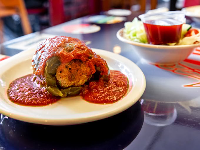 A stuffed pepper that's having an identity crisis as a work of art. That vibrant sauce creates a moat of flavor around this Italian fortress.
