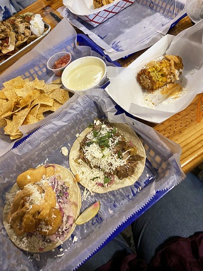 One drizzled with sauce, one topped with fresh pico – it's the taco version of fraternal twins, both equally deserving of your immediate attention.