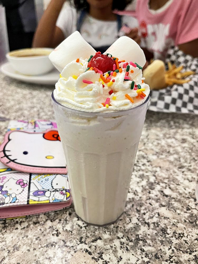 Marshmallows stand at attention atop this vanilla masterpiece, like tiny soldiers guarding the ultimate treasure—pure milkshake bliss.