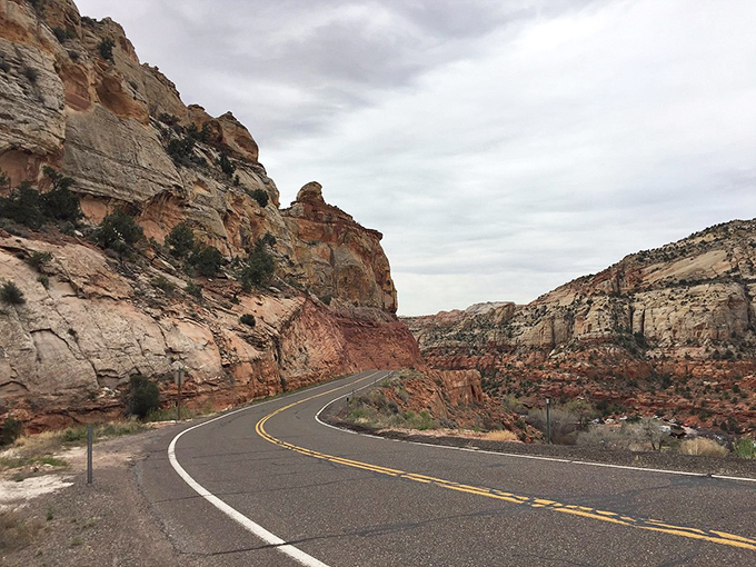 This winding road through Boulder's red rock country isn't just a drive—it's a journey through geological time.