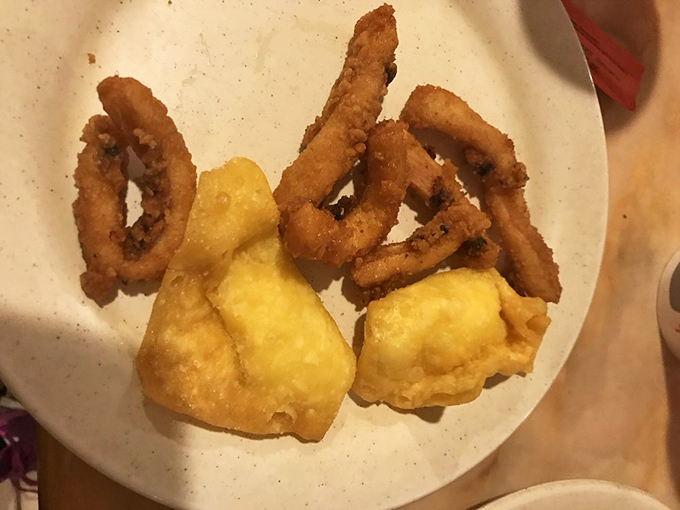 Crispy calamari rings and golden crab puffs—the dynamic duo of fried seafood that makes you wonder why you ever bothered with salad. 