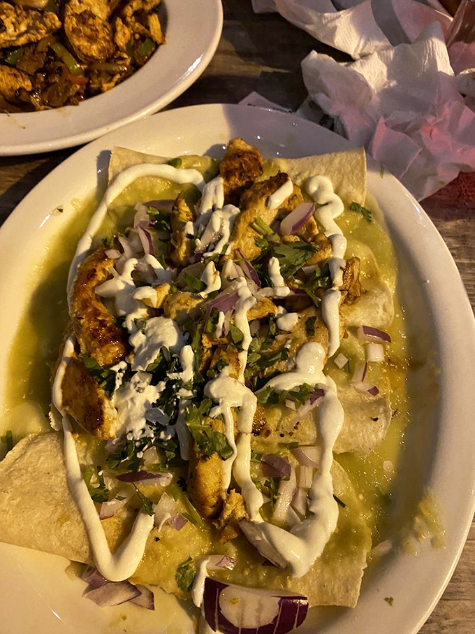 Chicken enchiladas bathed in verde sauce and adorned with a zigzag of cream—like edible art that happens to taste even better than it looks.
