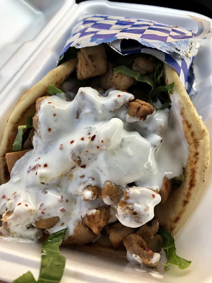 This chicken gyro isn't messing around—tender chunks of seasoned poultry tucked into a warm pita blanket with a generous tzatziki comforter.