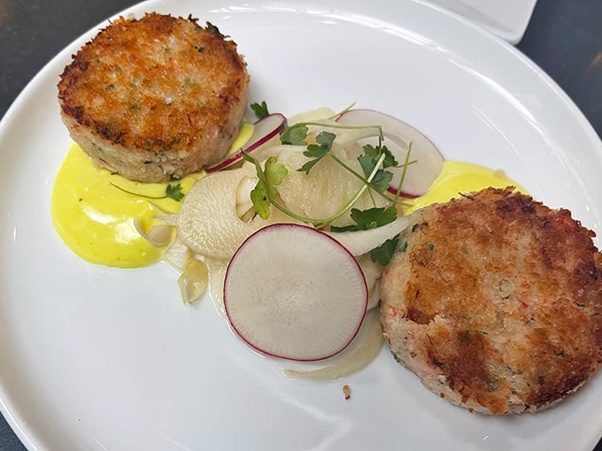 These crab cakes have more lump meat than filler—a rarity that deserves a standing ovation. The thin slices of radish add a peppery crunch that cuts through the richness.