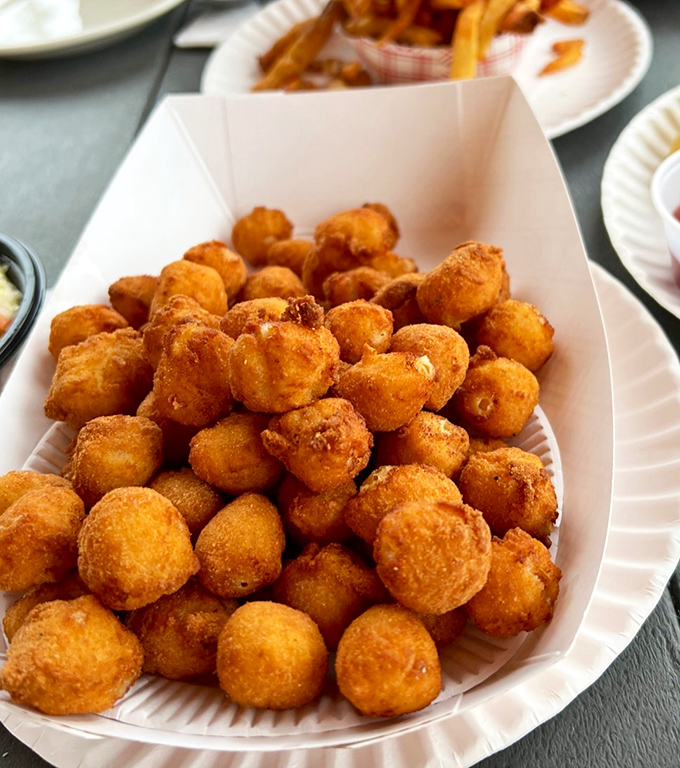 These golden-fried scallops are what seafood dreams are made of—sweet, tender treasures in a crispy cornmeal embrace.