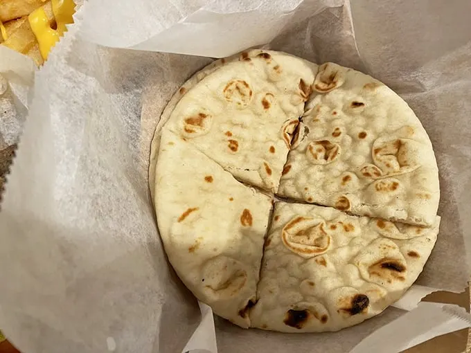 The unsung hero of any Greek meal—warm, fresh pita bread. Perfectly charred, pillowy soft, and ready for its supporting role in your lunch drama.
