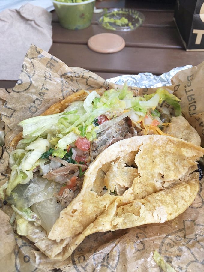 Pork carnitas nestled in a warm tortilla with all the fixings—proof that sometimes the simplest pleasures are the most profound.