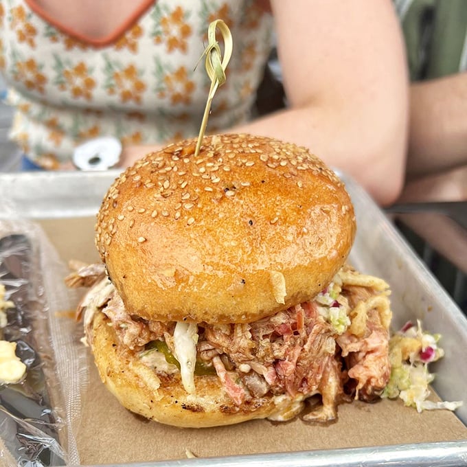 This isn't just a sandwich—it's an engineering marvel of pulled pork, slaw, and perfectly toasted bun that somehow manages to hold together until the last heavenly bite.