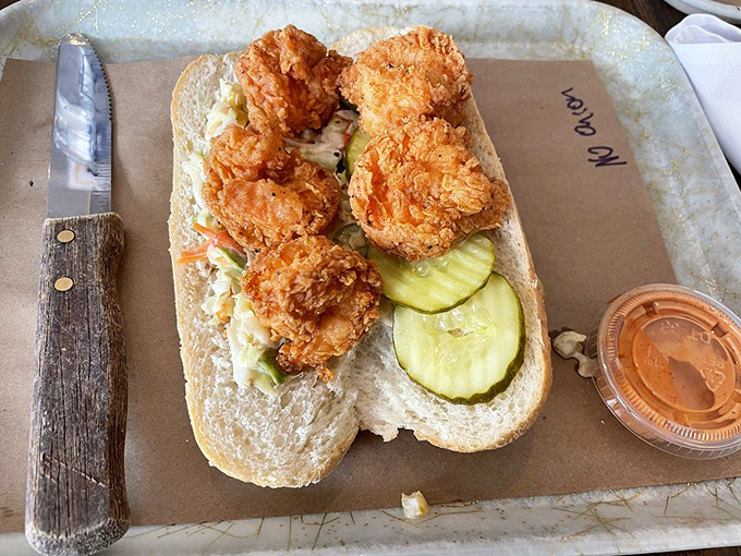 This sandwich isn't just food—it's architecture; crispy chicken stacked on pickles creating the skyscraper of satisfaction your lunch hour deserves.