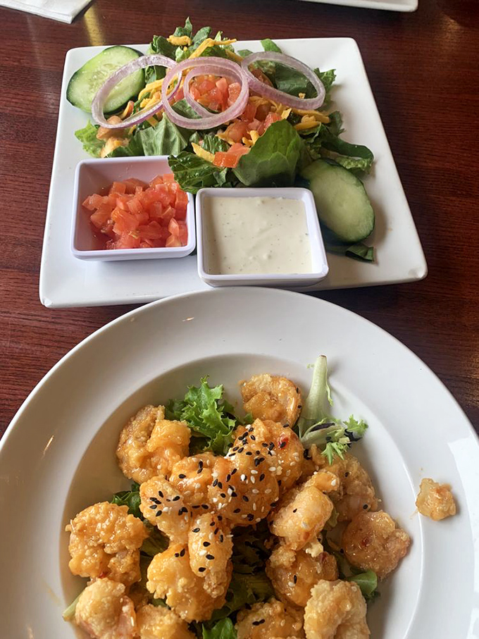 Fresh greens playing supporting role to crispy, golden shrimp—a duo that proves vegetables and fried food can peacefully coexist.