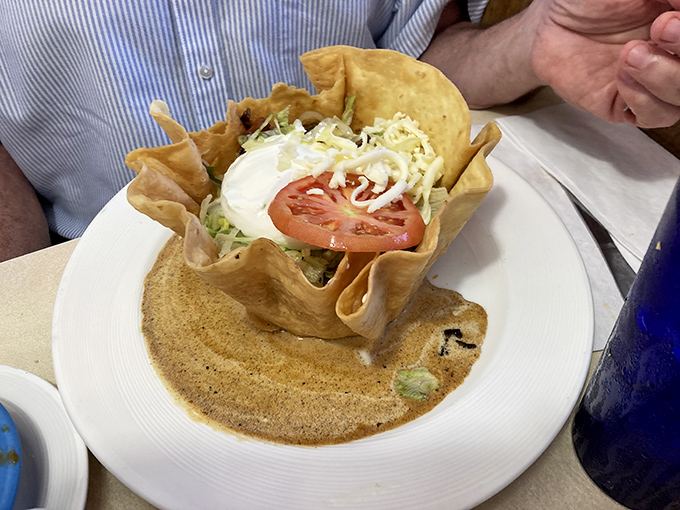 It's not just a taco bowl—it's architectural genius. The edible fortress protecting a kingdom of flavors, crowned with the perfect dollop of sour cream.