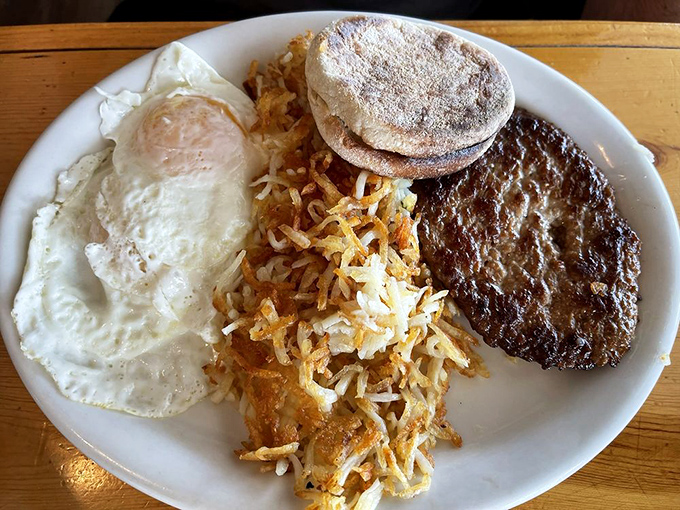 A breakfast plate that doesn't need filters or fancy lighting. Just eggs, hash browns, and a hamburger patty that would make your cardiologist wince and your taste buds applaud.
