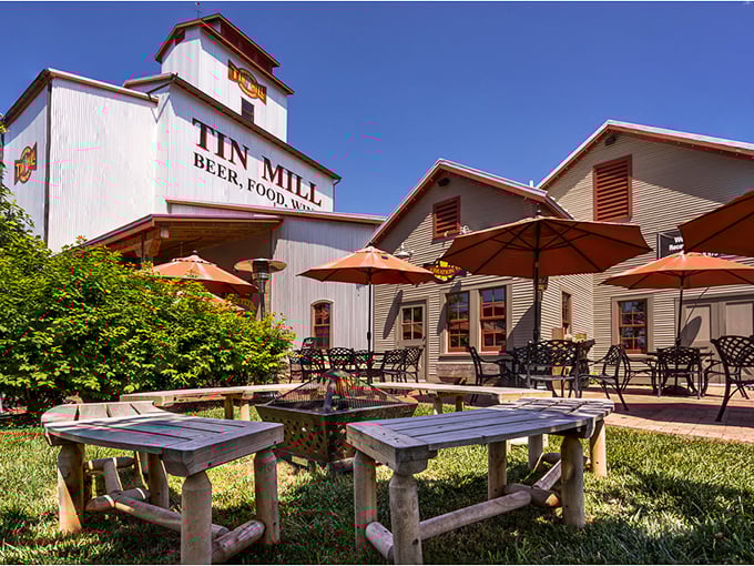 The Tin Mill's outdoor seating area isn't just a patio—it's an invitation to linger over local brews while the world rushes elsewhere.