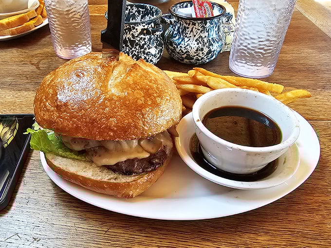 A burger that demands a two-handed commitment, served with au jus that transforms each bite into a flavor symphony.