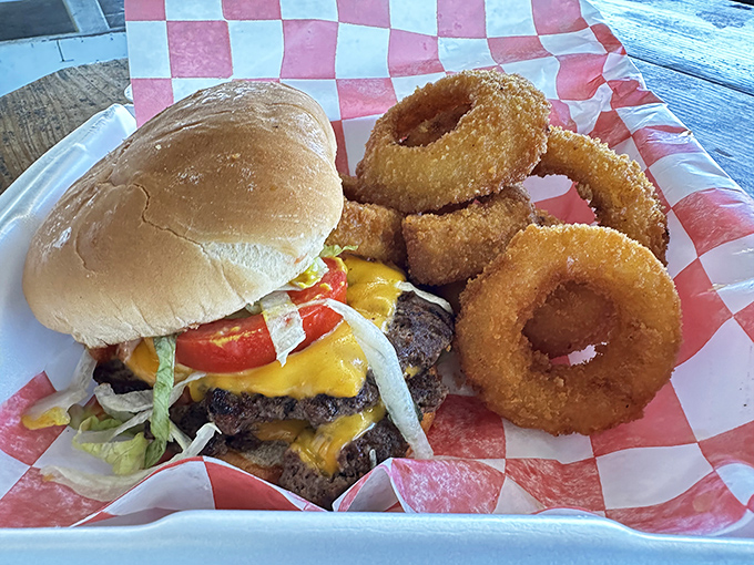 The burger-and-rings basket arrives on red-checkered paper—a delicious reminder that some traditions are worth preserving.