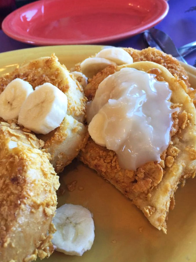 Cornflake-crusted French toast with bananas and cream. Whoever thought of coating bread in cereal deserves a Nobel Prize in Breakfast Sciences.