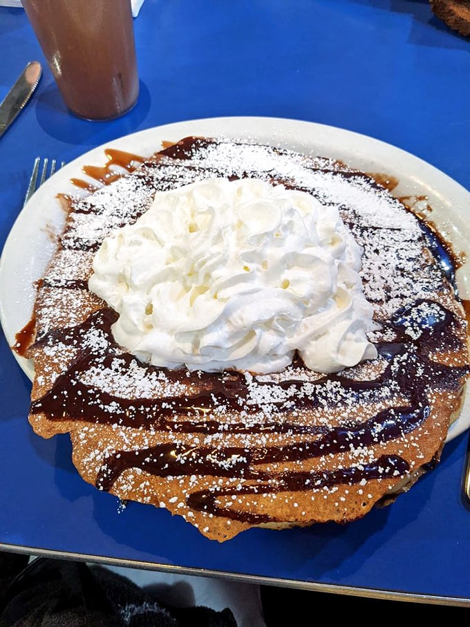 This isn't just a pancake—it's a dessert masquerading as breakfast. The whipped cream mountain makes morning feel like a celebration.