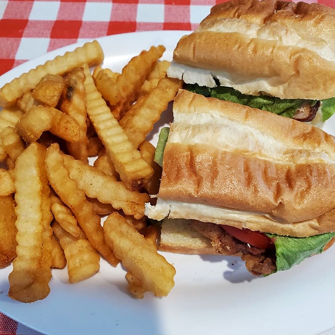 A sandwich that requires both hands and possibly a nap afterward. Those crinkle fries aren't just sides—they're supporting actors deserving their own award.