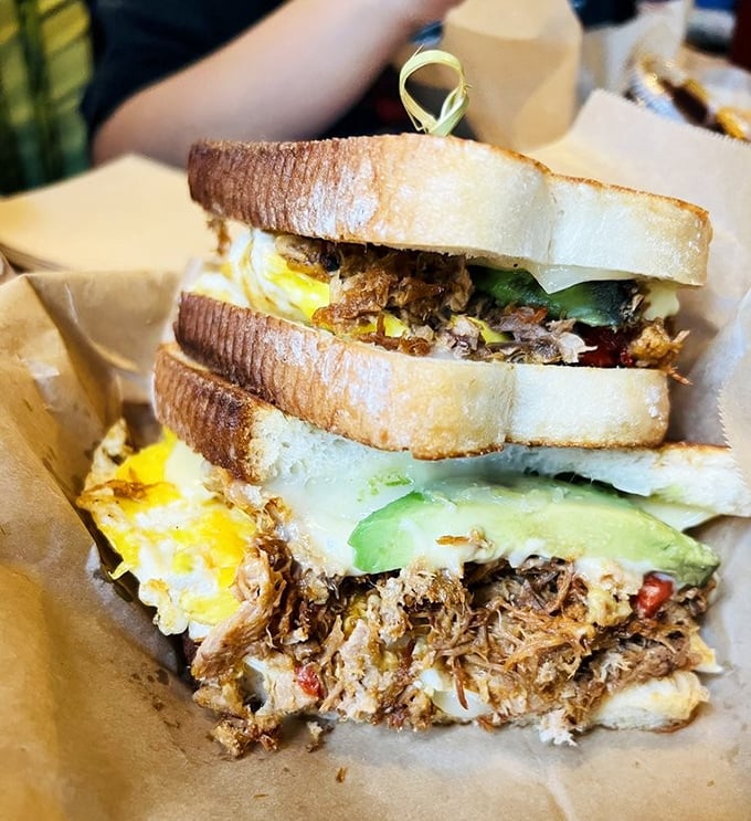 The sandwich that launched a thousand road trips—tender pork, egg, and avocado stacked between bread that's been kissed by the perfect toast.