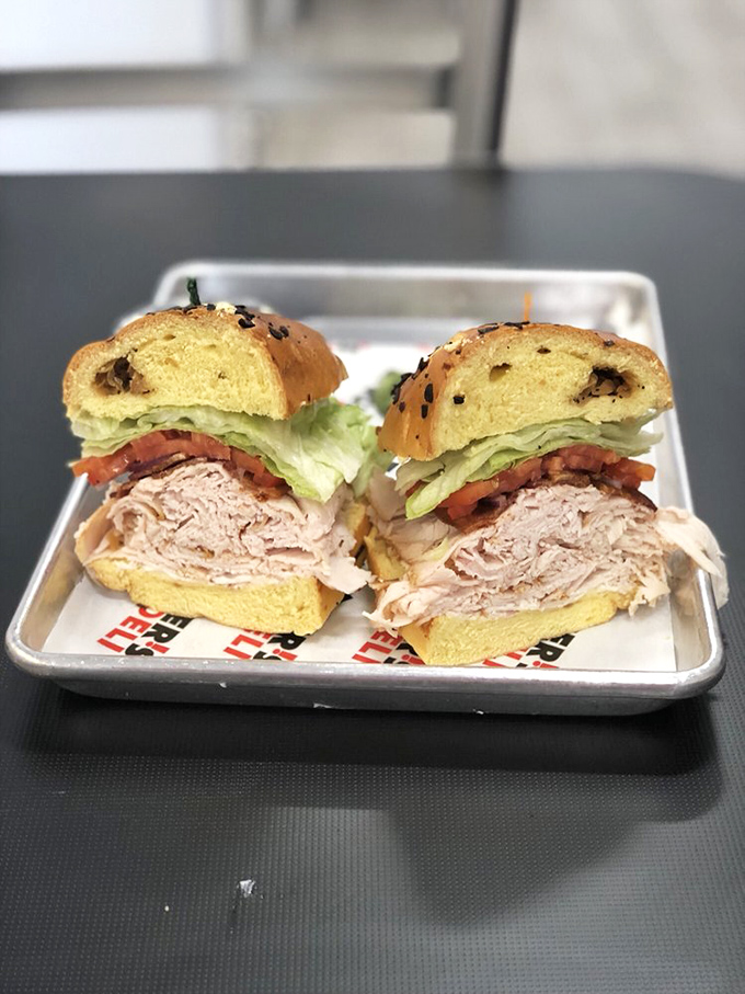 A proper turkey sandwich on a proper bagel—stacked high enough to make your jaw stretch but not so tall it requires engineering.