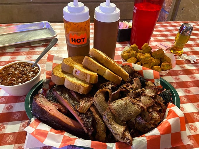 This isn't just a platter—it's a carnivore's dream state. Multiple meats, sauce bottles standing by, and bread for impromptu sandwiching. Strategic eating at its finest.