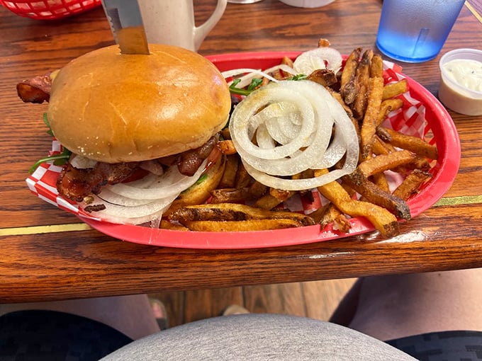 A burger that demands to be photographed before eaten. Those thick-cut fries aren't just sides—they're co-stars in this delicious production.