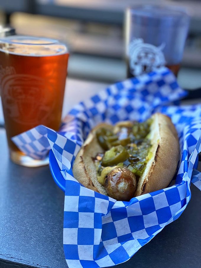 This isn't just a hot dog—it's a sausage with ambition, nestled in a fresh bun and dressed with enough toppings to make it blush. 