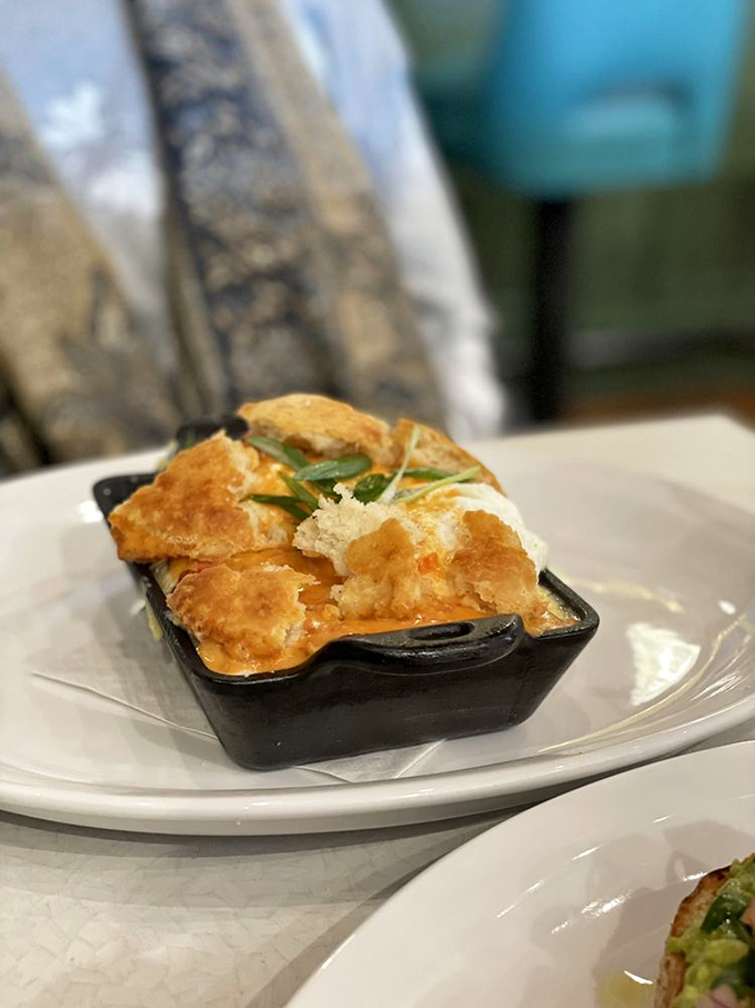 Not all heroes wear capes—some come in cast iron skillets with perfectly melted cheese and a side of buttery biscuit.