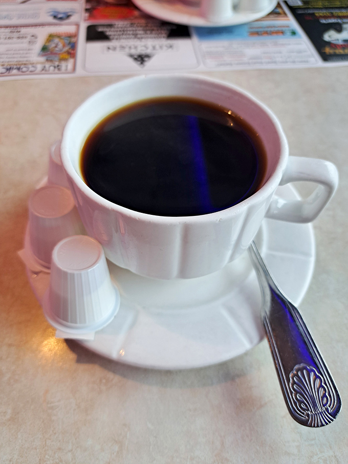 The humble diner coffee cup—holding the elixir that's launched a thousand road trips and solved countless crossword puzzles.