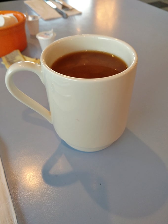 That first sip of diner coffee – the liquid alarm clock that doesn't just wake you up, it makes you glad you're awake.