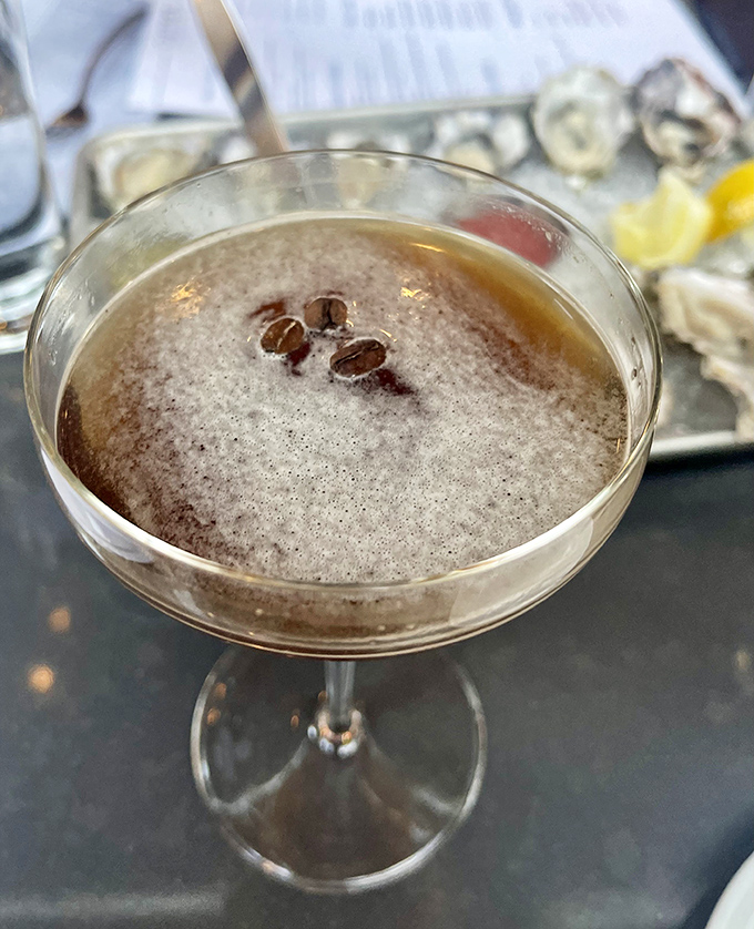 An espresso martini that promises to keep you awake long enough to remember every bite of your meal. Coffee beans floating like tiny life rafts of caffeine.