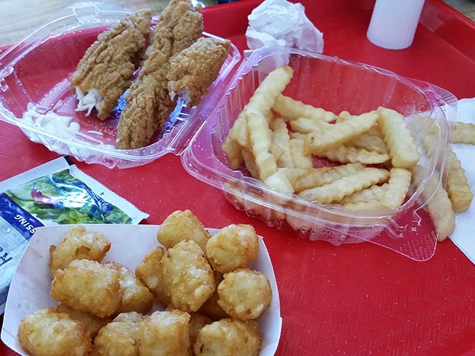 Southern comfort on a red tray—crispy fish, crinkle-cut fries, and tater tots that make you question why you'd ever need fancy dining.