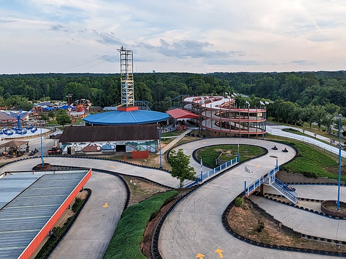 The aerial view reveals the park's thoughtful layout – curving go-kart tracks wind through greenery, promising competitive thrills for speed demons of all ages.