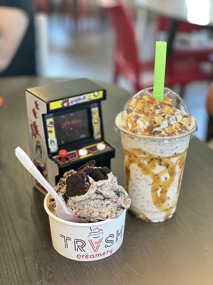Dessert duality at its finest—a cup for now, a shake for later, with a miniature arcade game standing guard against potential treat thieves.