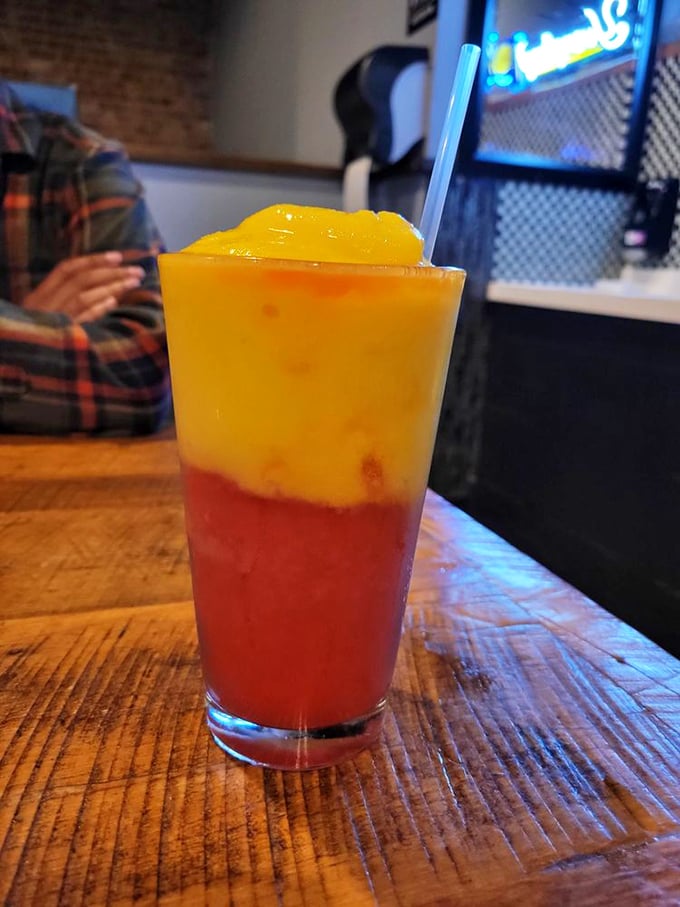 A two-toned tropical libation that looks like a Midwestern sunset but tastes like a Caribbean vacation—no passport required.