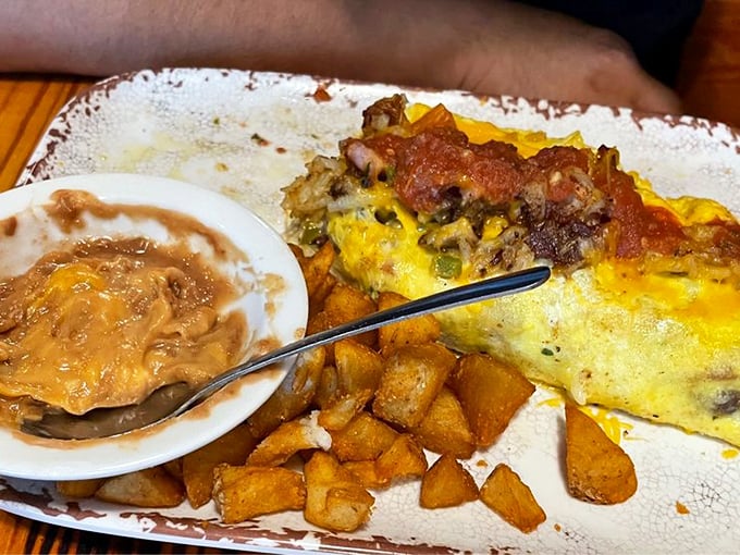 When an omelet meets Texas-sized ambition, this happens. Those country potatoes on the side aren't just a garnish—they're essential supporting actors.