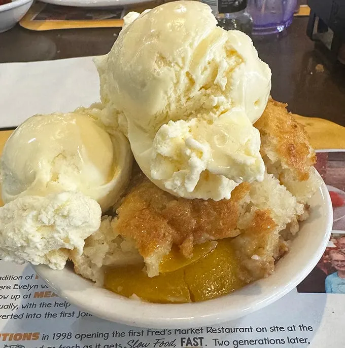 Peach cobbler crowned with vanilla ice cream—dessert royalty that demands your respect and your spoon. Summer in a bowl.