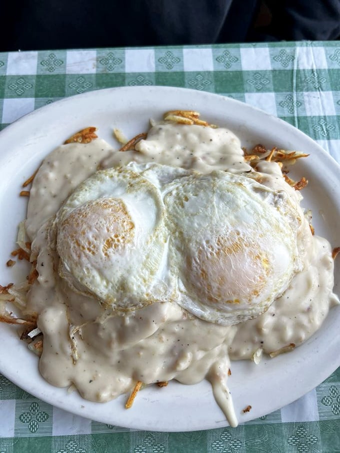 Eggs and hash browns swimming in country gravy—a breakfast so comforting it's like wearing your favorite sweatpants at a five-star resort.