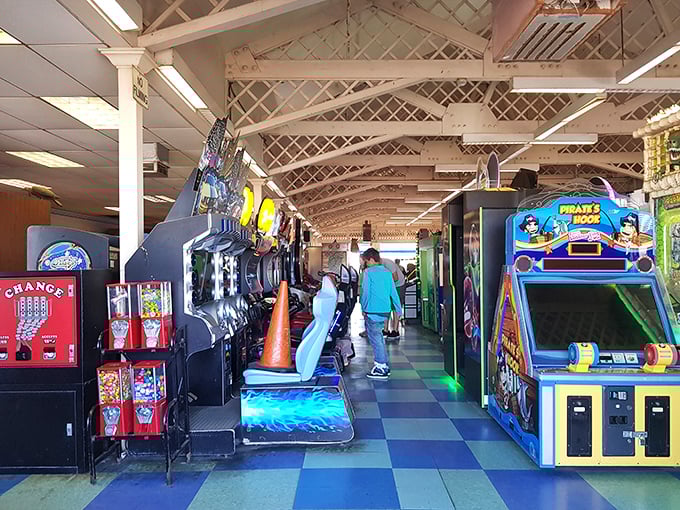 The arcade—where quarters disappear faster than ice cream on a hot day, but the thrill of almost winning that giant stuffed banana makes it all worthwhile.