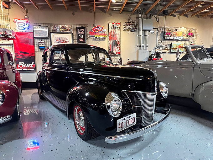 The 1940 Ford—automotive royalty in glossy black. This isn't transportation; it's time travel with whitewall tires and running boards.