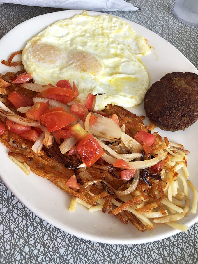 Hash browns with fresh toppings, eggs, and a sausage patty—the holy trinity of breakfast that's kept Atlantans functioning since before smartphones ruined our attention spans.