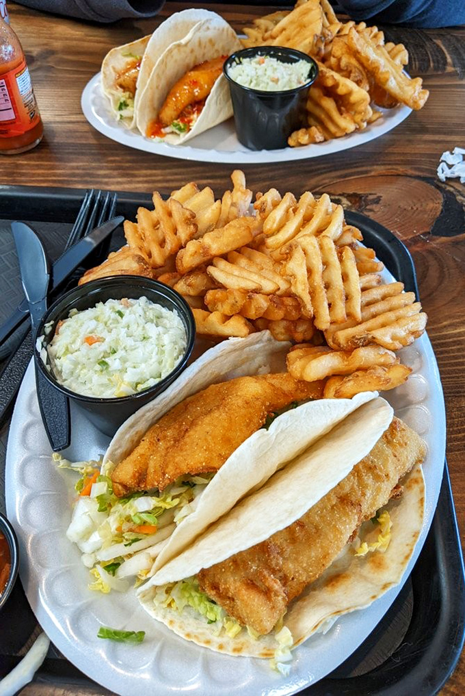A feast fit for Neptune himself! Crispy perch tacos, waffle fries, and creamy coleslaw—the holy trinity of lakeside dining.