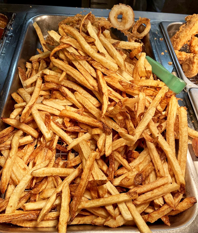 Hand-cut fries piled high like golden treasure – crispy on the outside, fluffy inside, and worth every extra minute on the treadmill tomorrow.