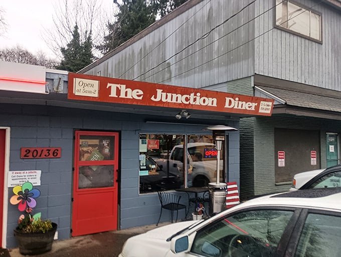 That cheerful red door is the gateway to a blue-building breakfast paradise where calories don't count and coffee cups never empty.