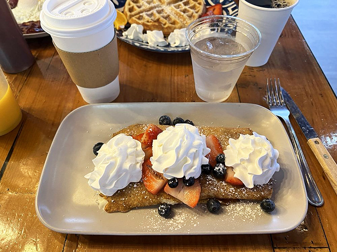 Berry-topped crepes with clouds of whipped cream—because sometimes breakfast should feel like you're getting away with something naughty.