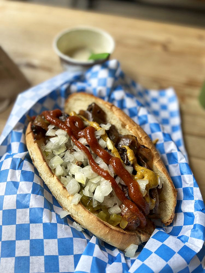 A sausage masterpiece with the works—where every bite delivers a perfect balance of snap, tang, and savory satisfaction. No ketchup needed here. 
